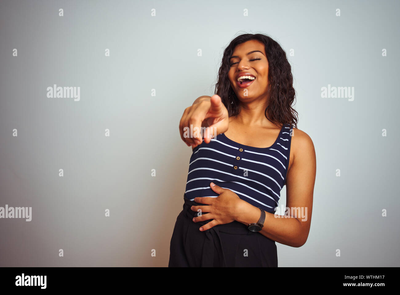 Transsexual transgender woman wearing striped t-shirt over isolated ...