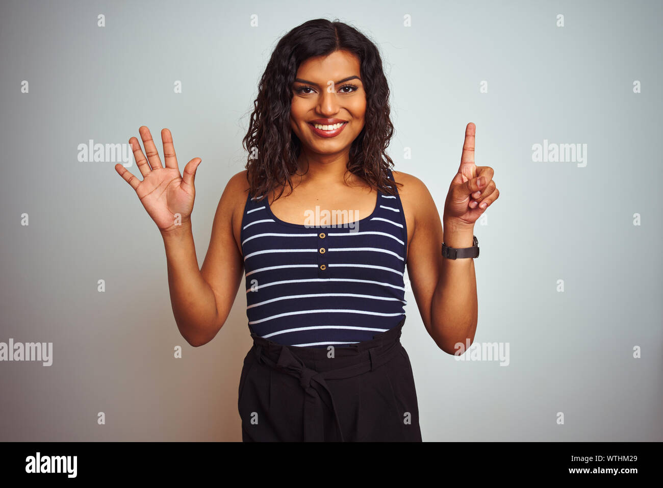 Transsexual transgender woman wearing striped t-shirt over isolated ...