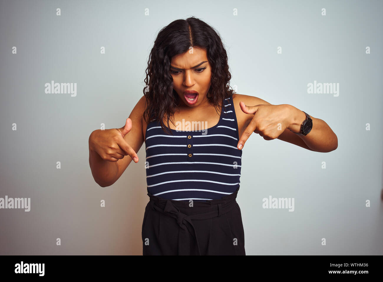 Transsexual transgender woman wearing striped t-shirt over isolated ...