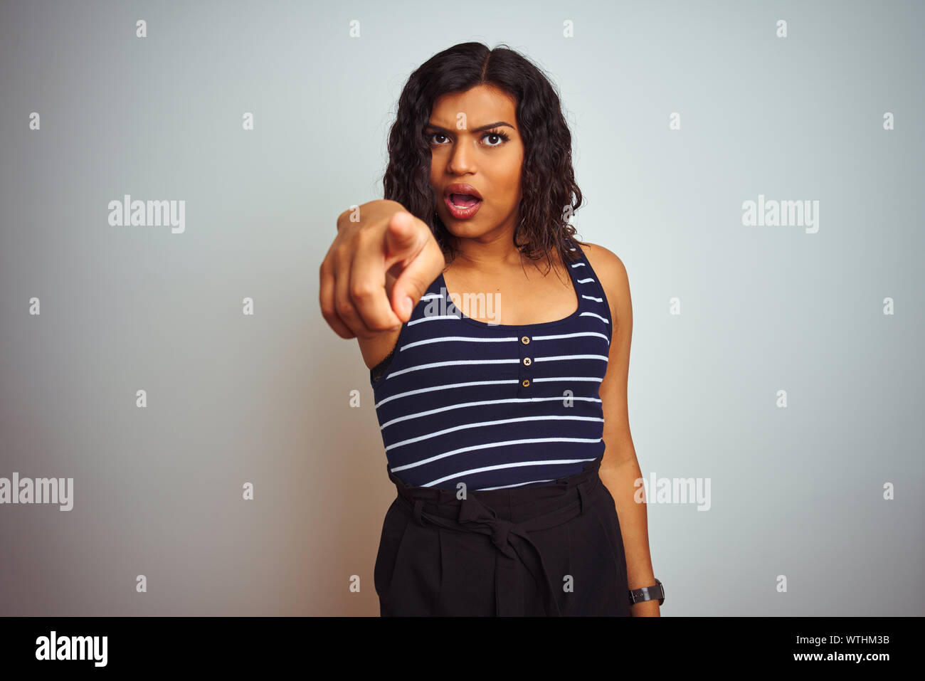 Transsexual transgender woman wearing striped t-shirt over isolated ...