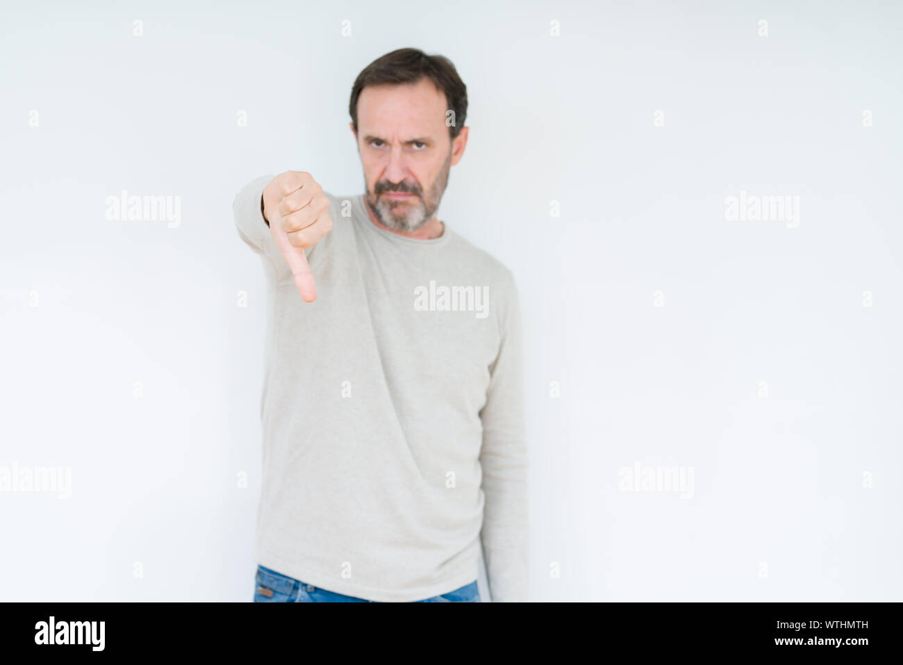 Elegant senior man over isolated background looking unhappy and angry ...