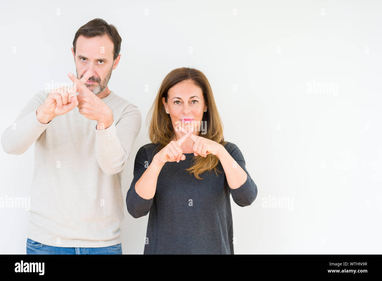 Beautiful middle age couple in love over isolated background Rejection ...