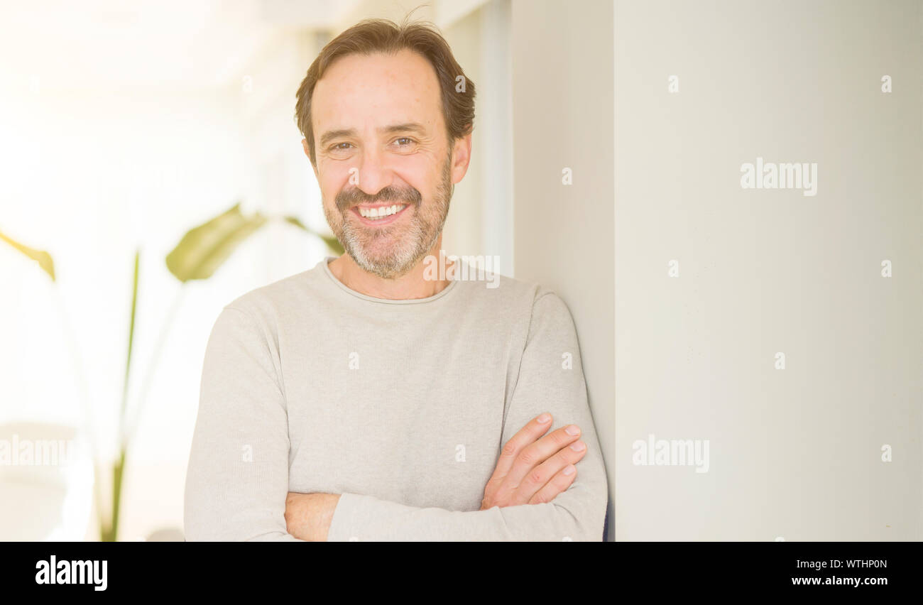 Handsome middle age man smiling looking at the camera at home Stock ...