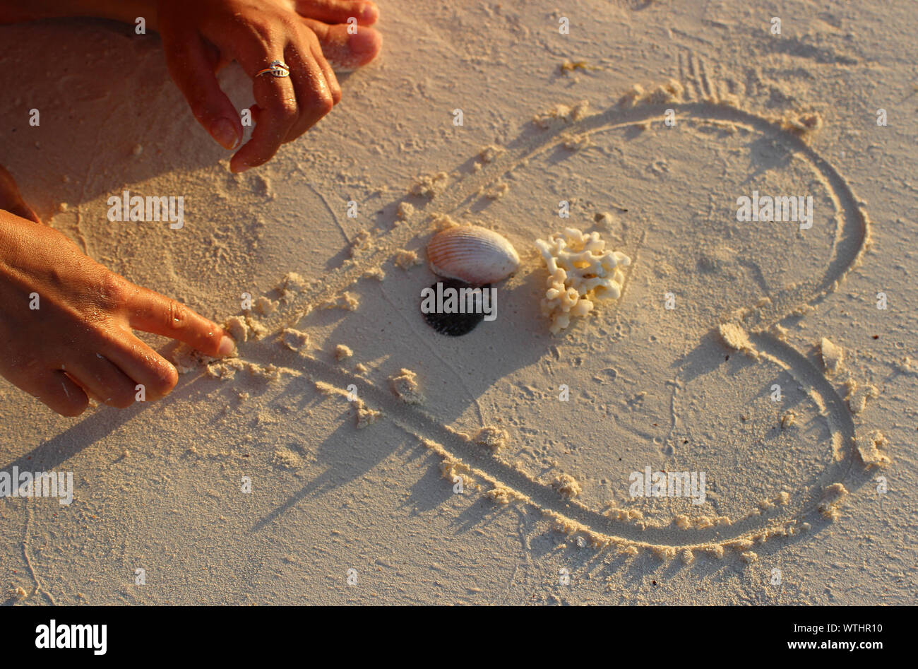 Drawing in sand with finger hi-res stock photography and images - Alamy