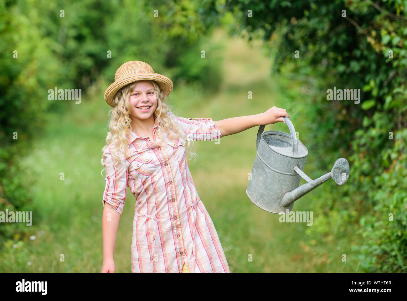 Optimize water use. Watering tools. Girl child hold watering can ...