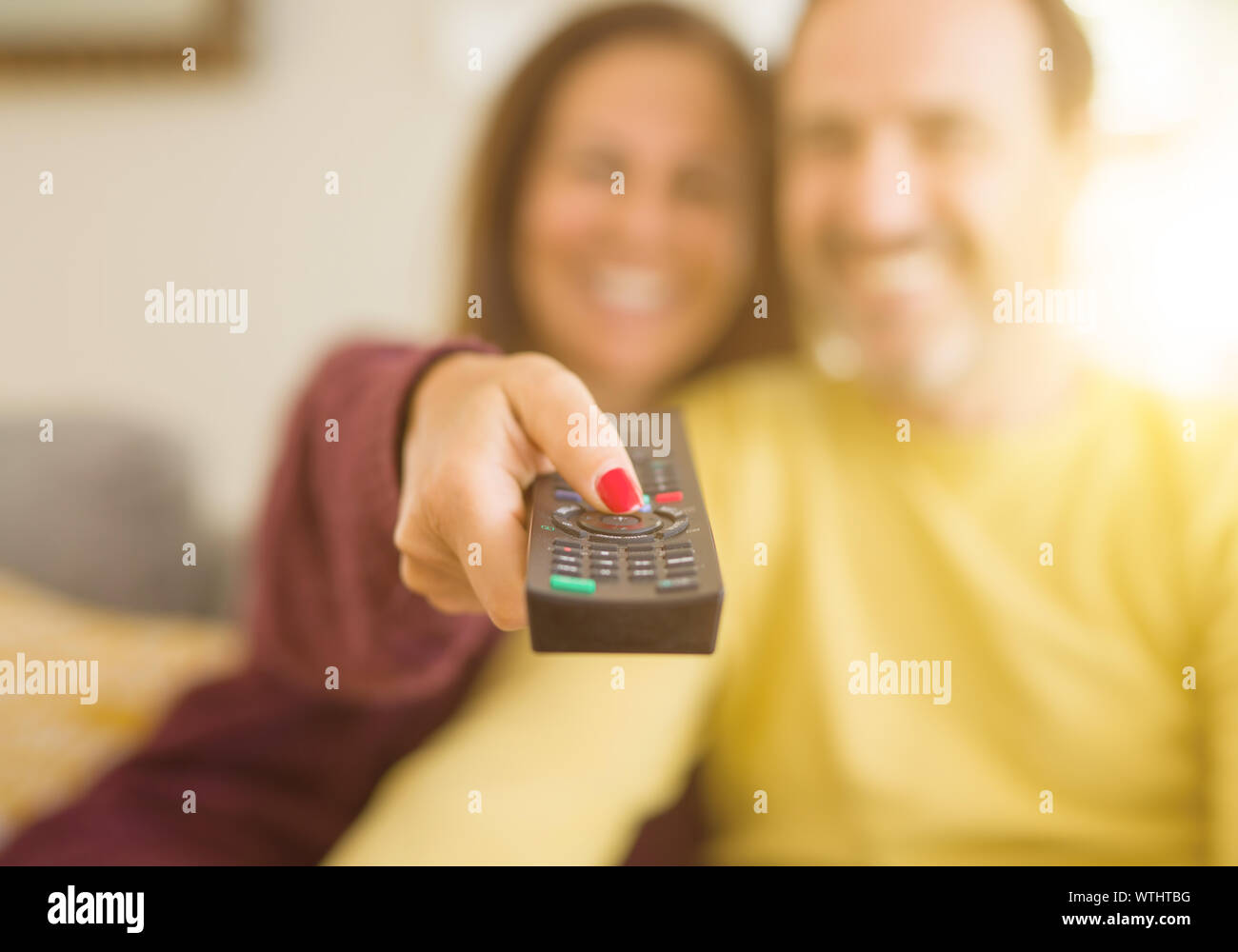 Romantic middle age couple watching tv on the sofa at home Stock Photo ...