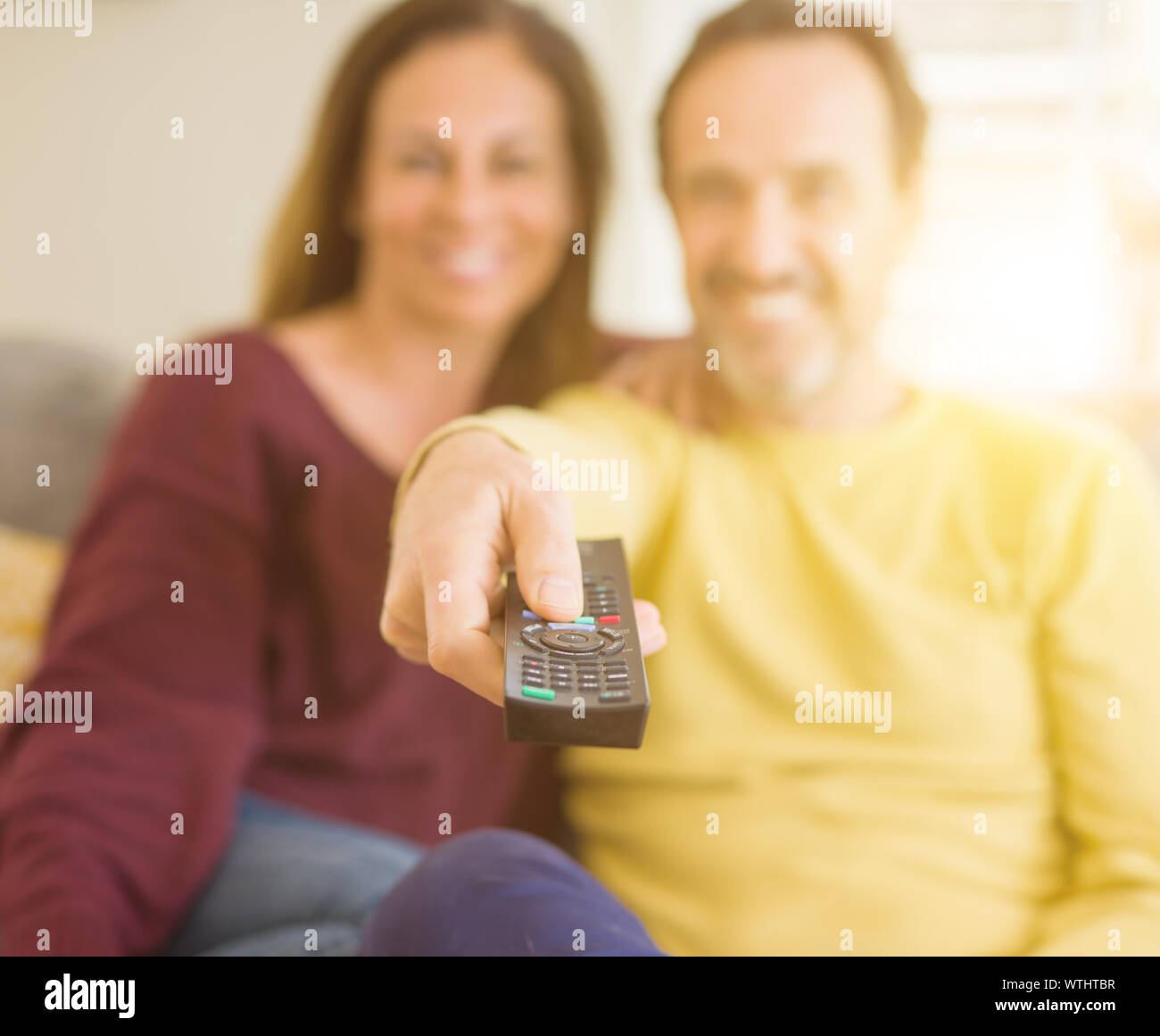 Romantic middle age couple watching tv on the sofa at home Stock Photo ...