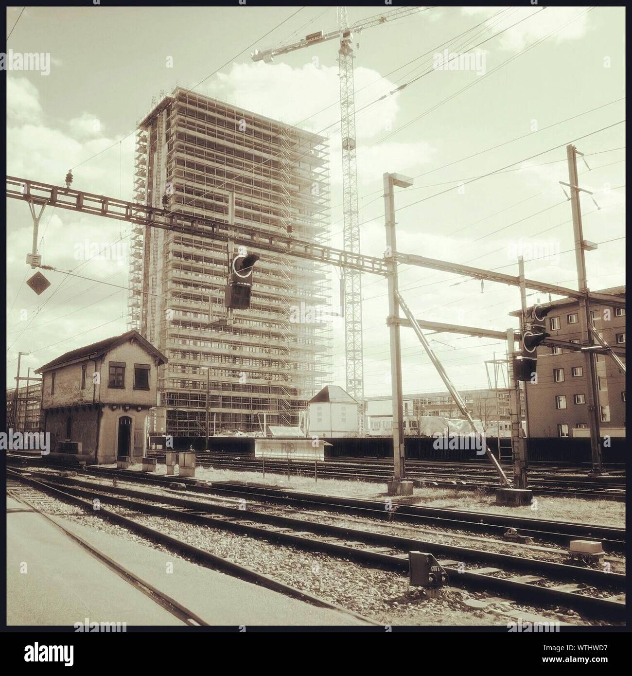 Railroad Track With Construction Building In Background Stock Photo - Alamy