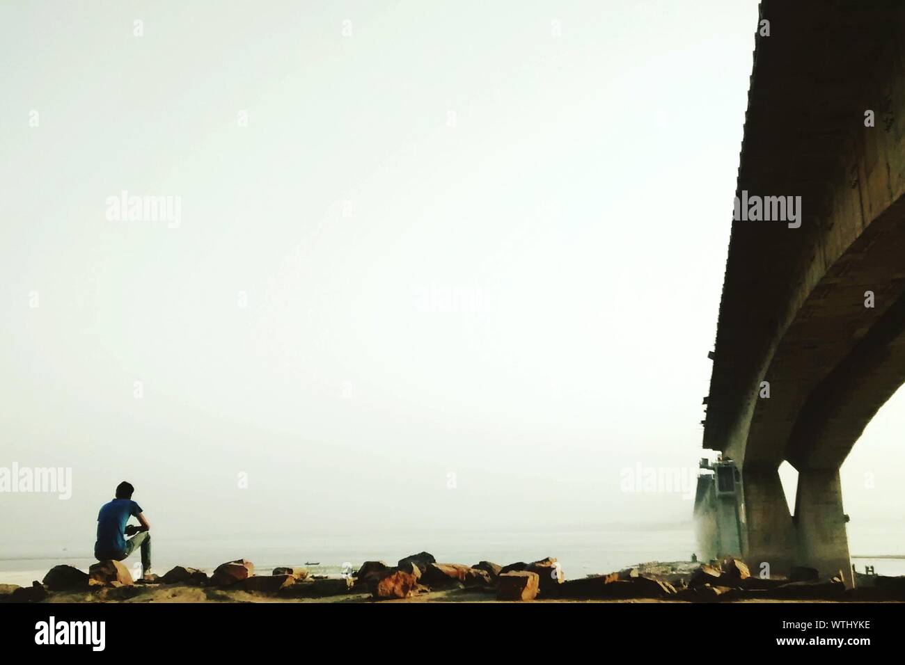 Man sitting on bridge in hi-res stock photography and images - Alamy