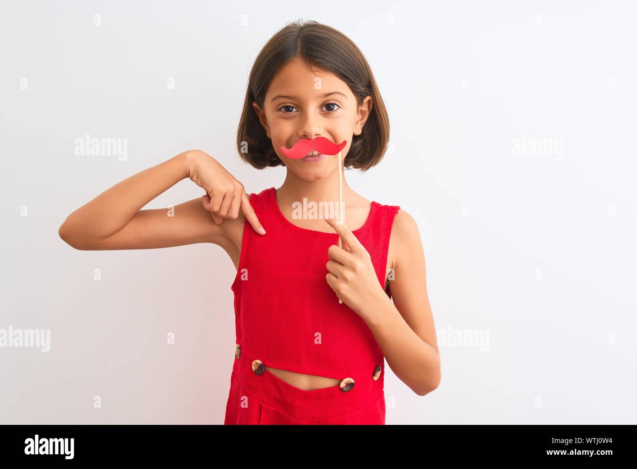 Beautiful child girl holding fanny party mustache standing over ...