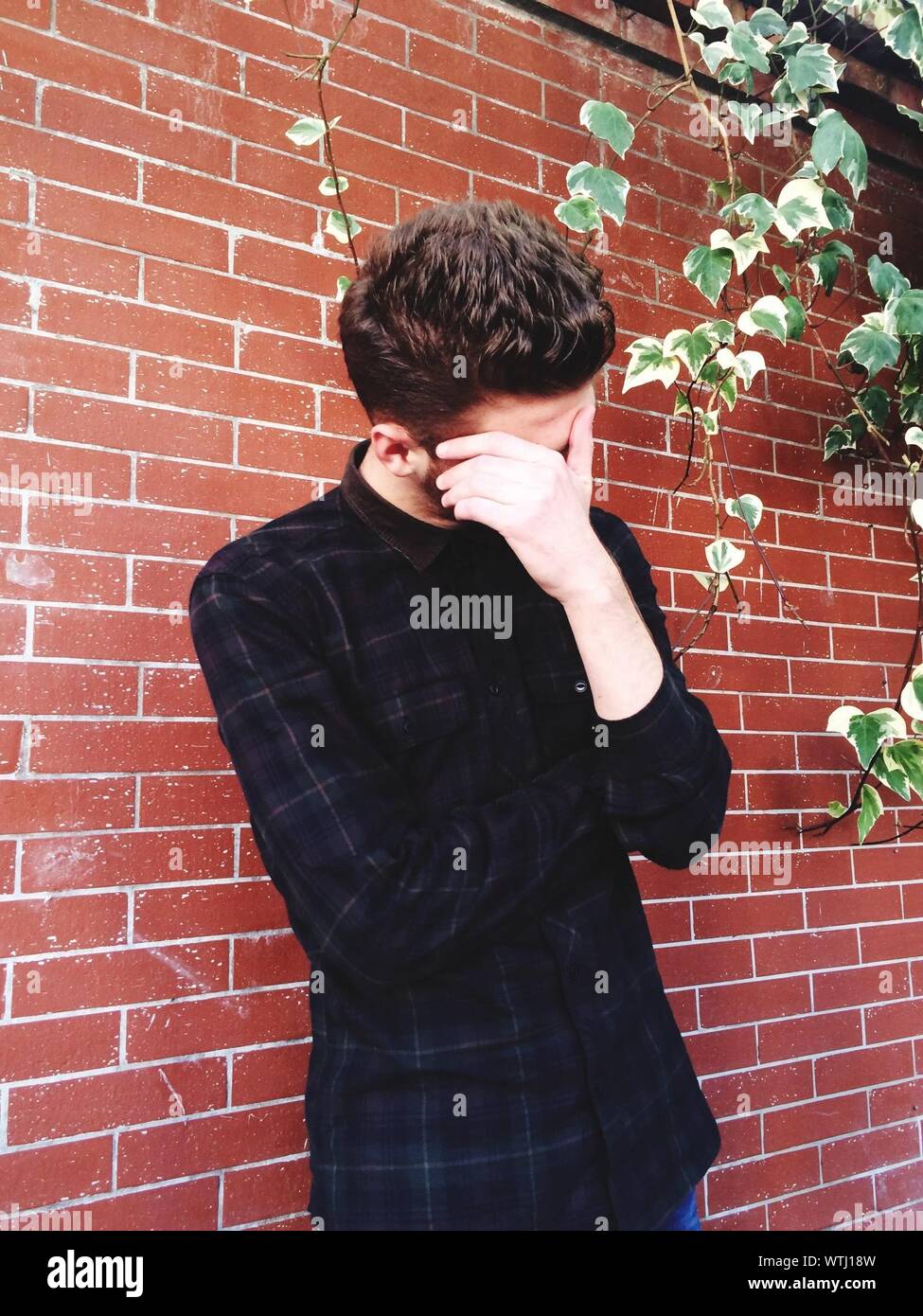 Hiding his embarrassment hi-res stock photography and images - Alamy