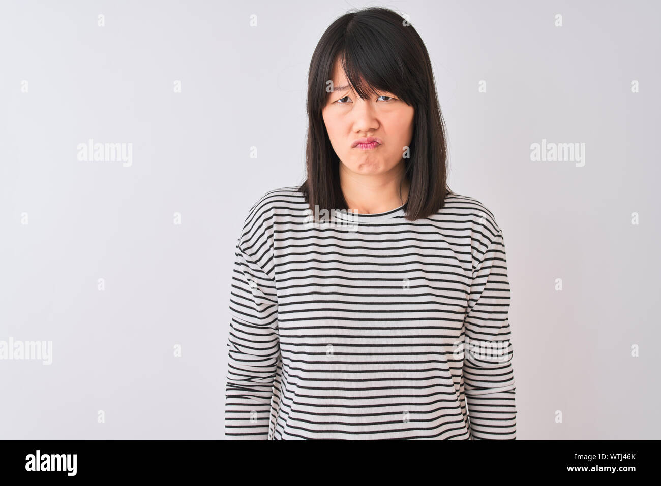 Young beautiful chinese woman wearing black striped t-shirt over ...
