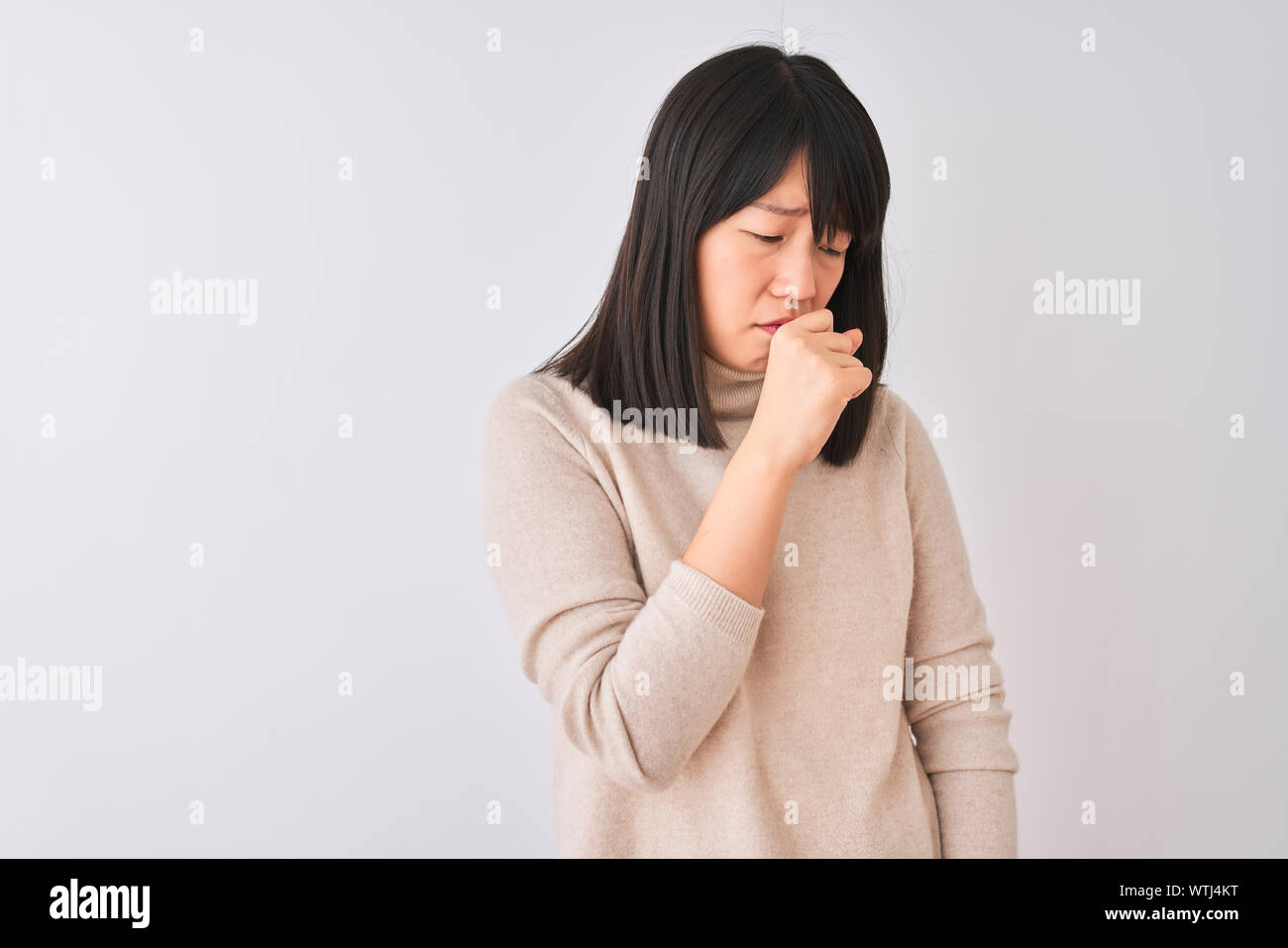 Young beautiful chinese woman wearing turtleneck sweater over isolated ...