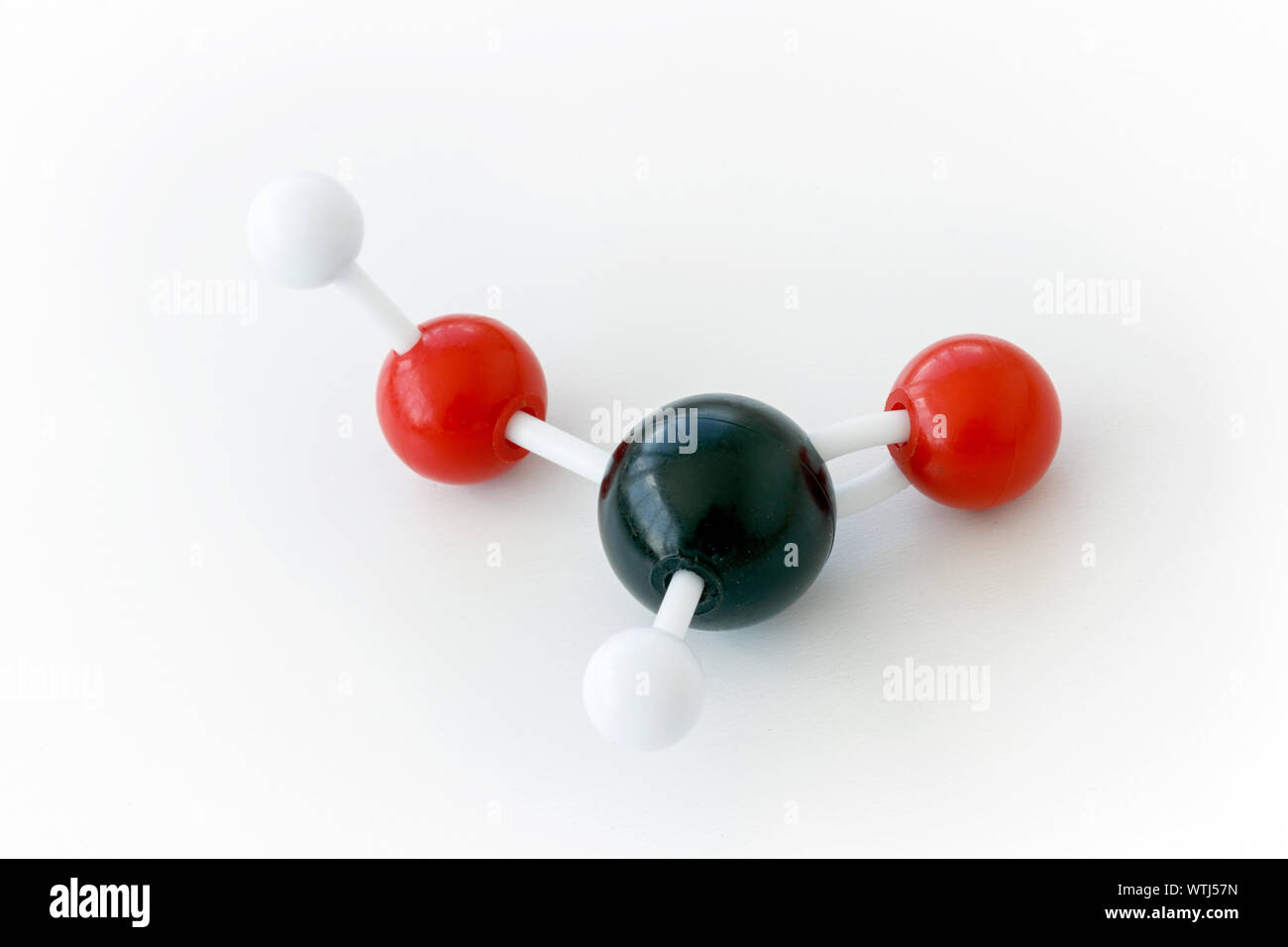 Plastic ball-and-stick model of a formic acid molecule (CH2O2) on a ...