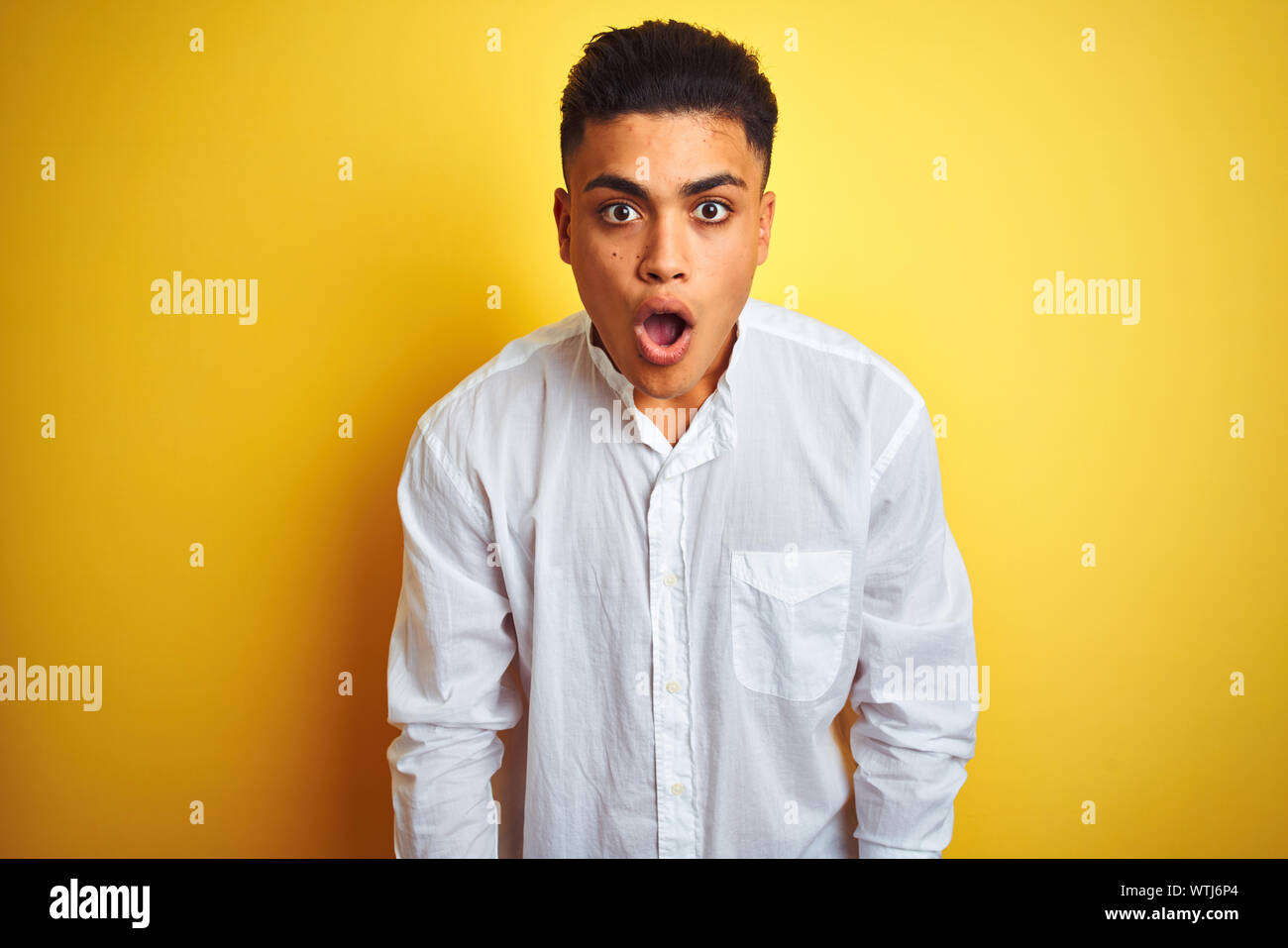 Young brazilian businessman wearing elegant shirt standing over ...