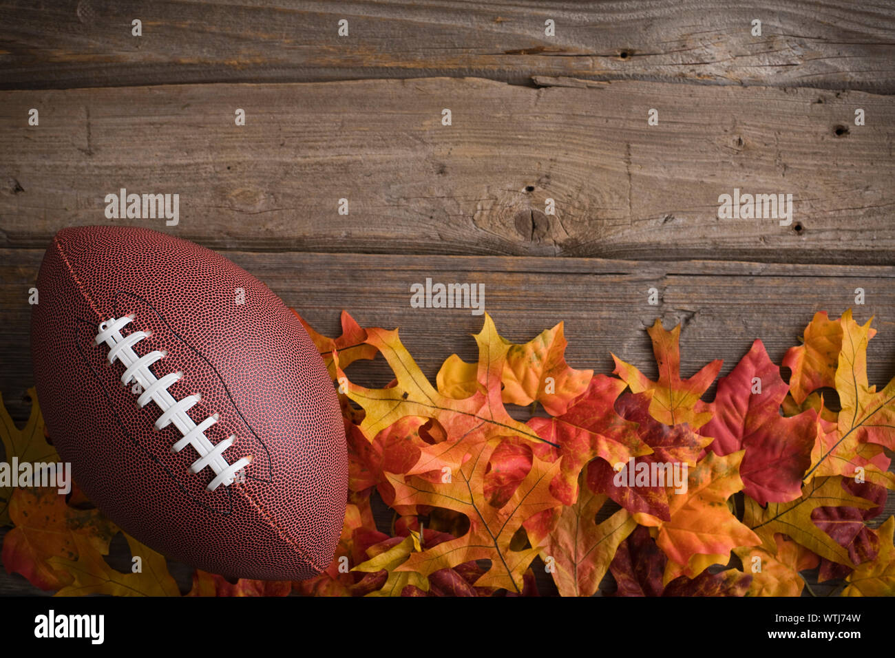 Football with autumn foliage Stock Photo - Alamy