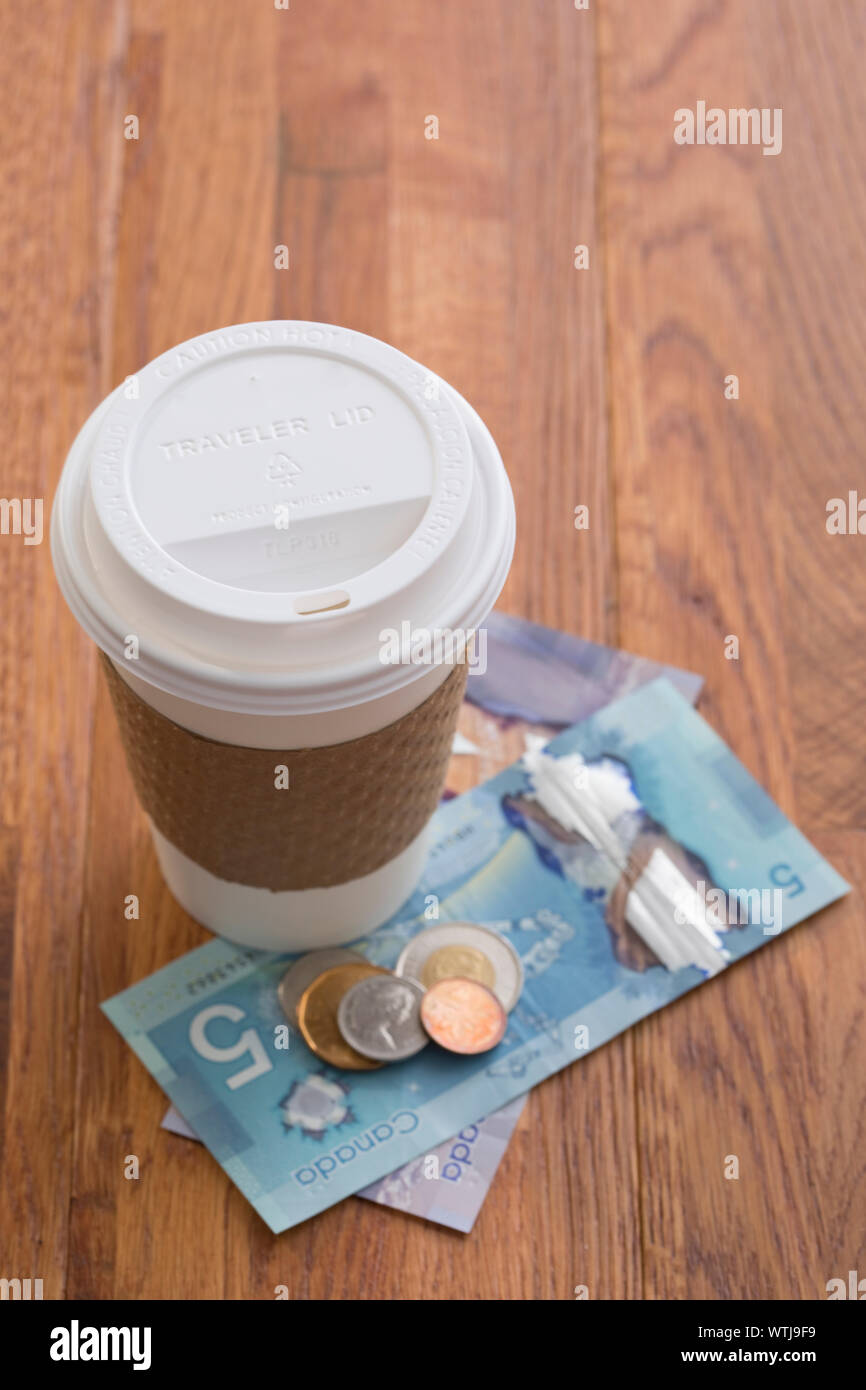 Coffee to go with cash money Stock Photo - Alamy