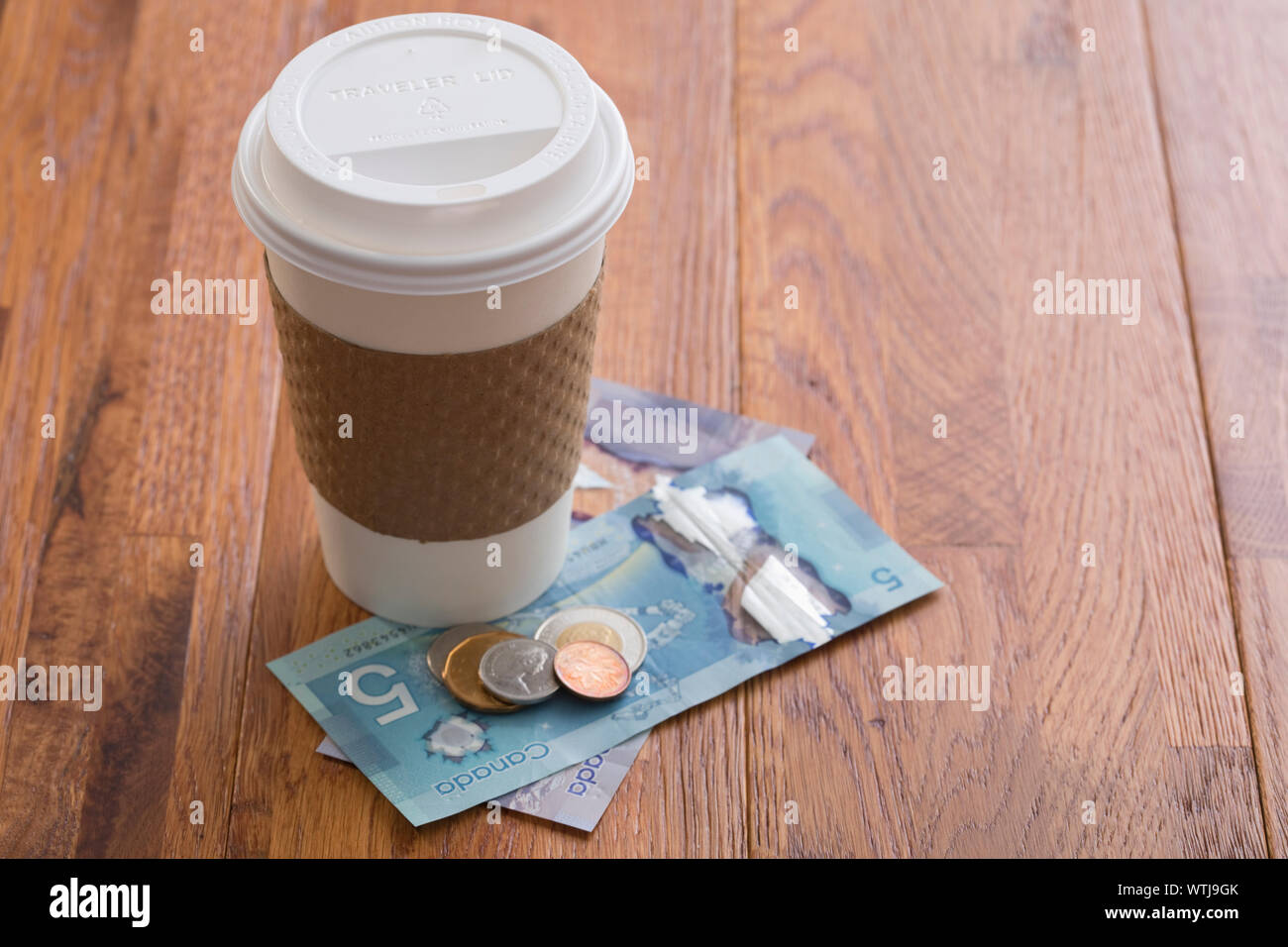 Coffee to go with cash money Stock Photo - Alamy