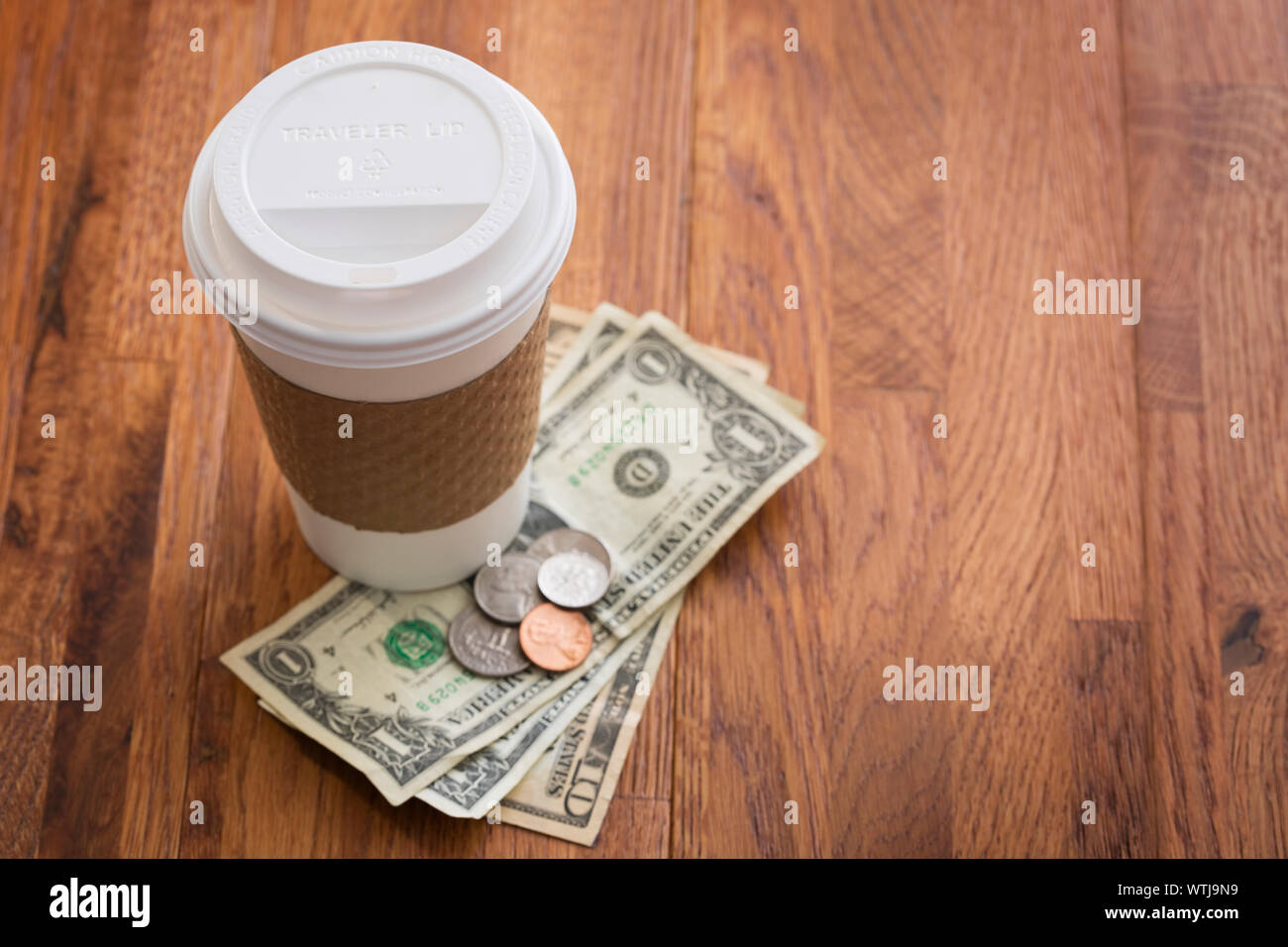 Coffee to go with cash money Stock Photo - Alamy