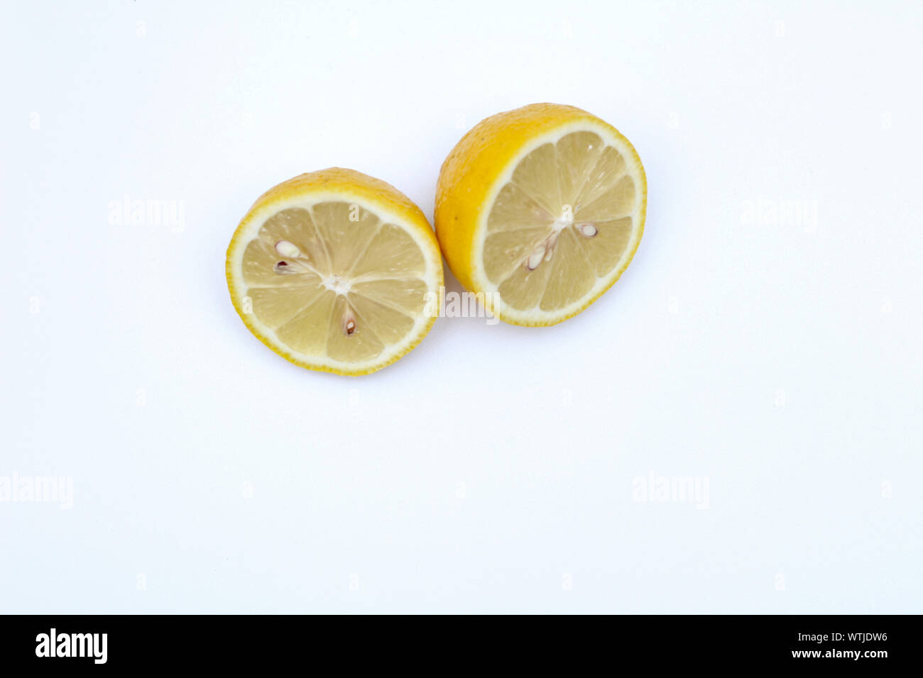 Fresh, ripe, isolated, juicy bisected lemon on a white background ...