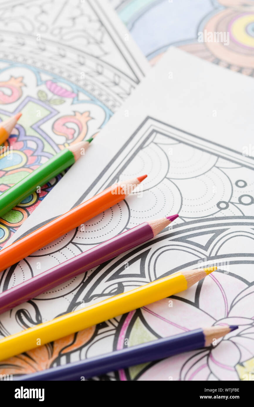 Colored pencils on coloring book page Stock Photo - Alamy