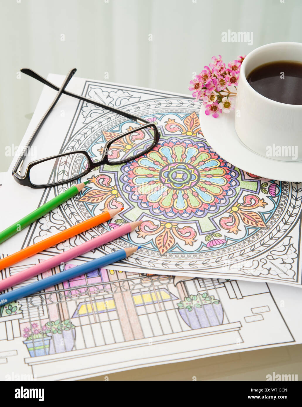 Eyeglasses and colored pencils on coloring book page Stock Photo - Alamy