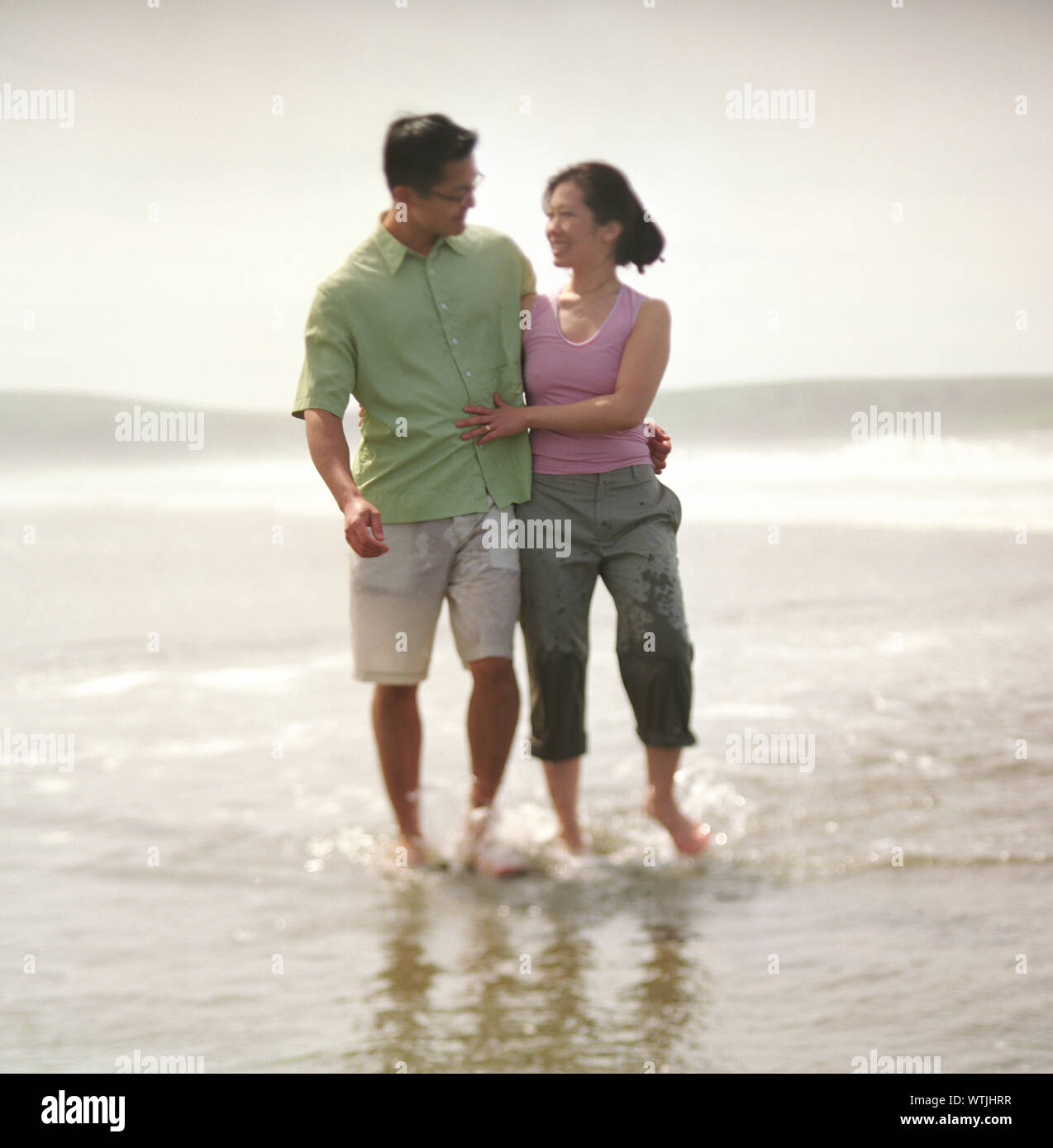 Front view of a happy couple on a beach Stock Photo - Alamy