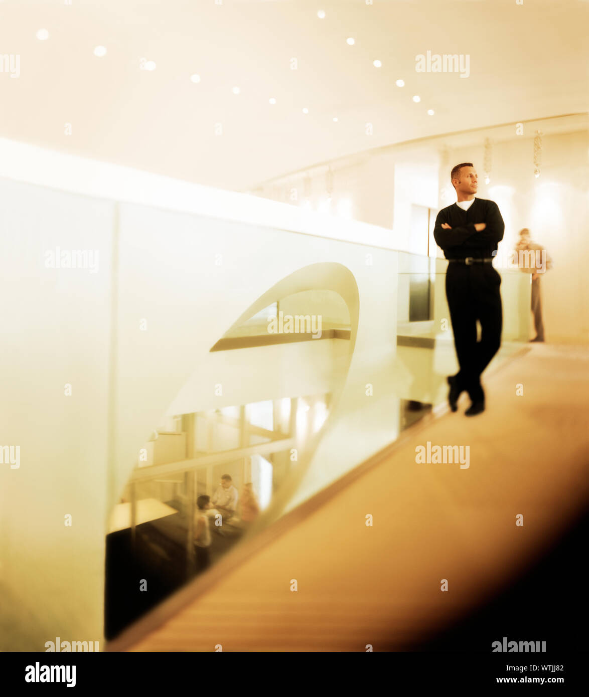 A man standing inside an elegantly furnished corridor Stock Photo - Alamy