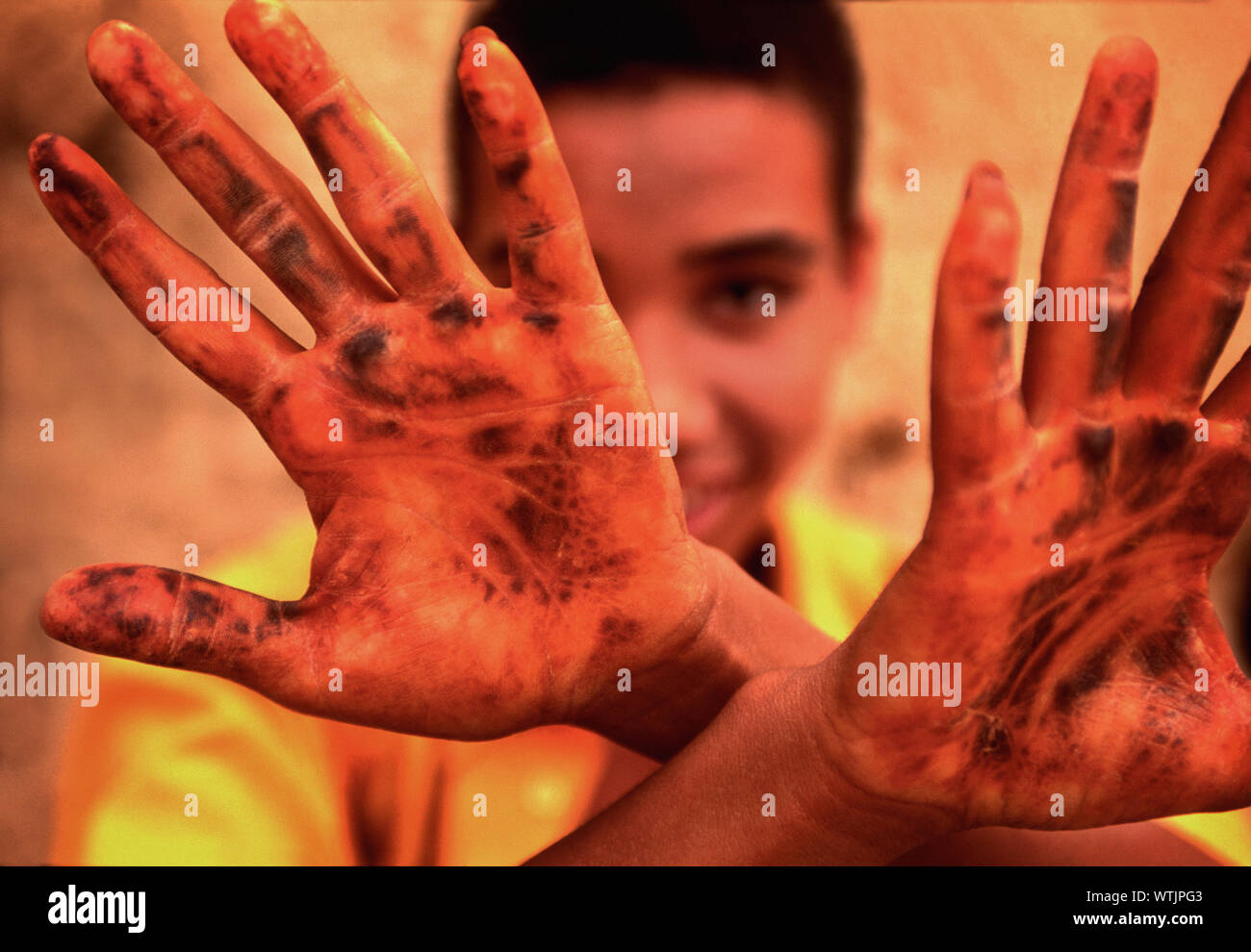 A young boy is displaying his stained hands Stock Photo - Alamy