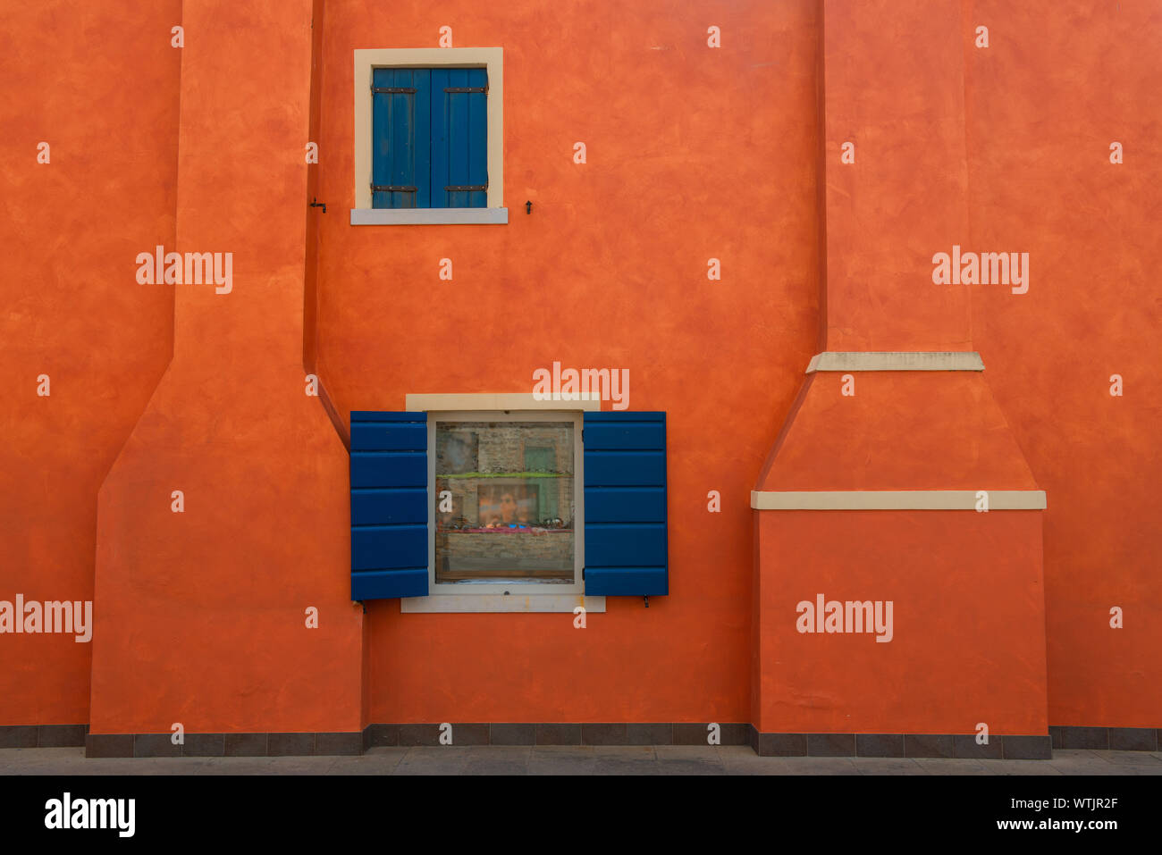 Caorle house colored with blue windows Stock Photo - Alamy