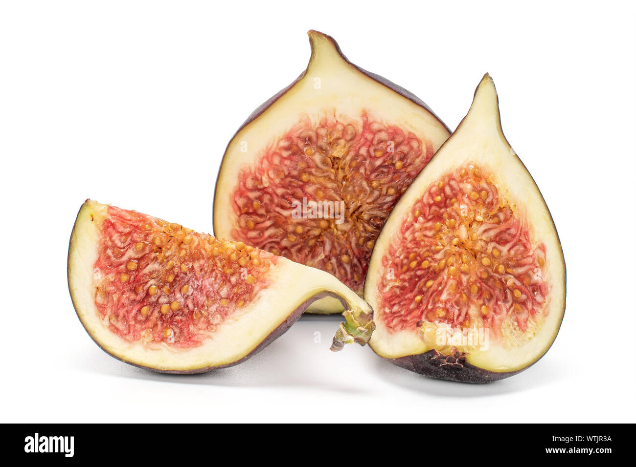 Group of one half two slices of fresh fig fruit isolated on white ...