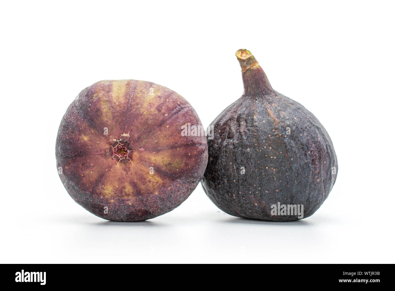 Group of two whole fresh fig fruit isolated on white background Stock ...