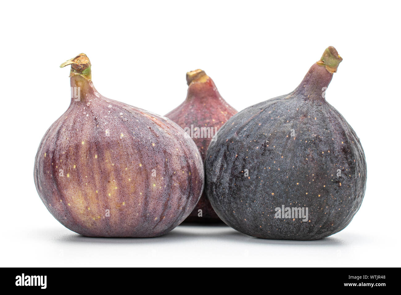 Group of three whole fresh fig fruit isolated on white background Stock ...