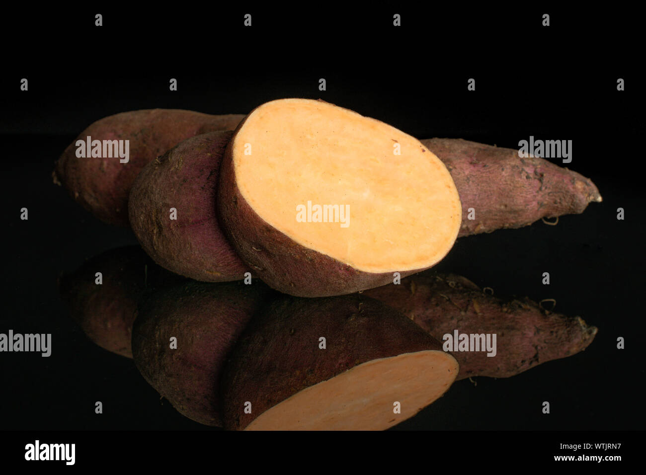 Group of one whole one half of fresh brown sweet potato isolated on ...