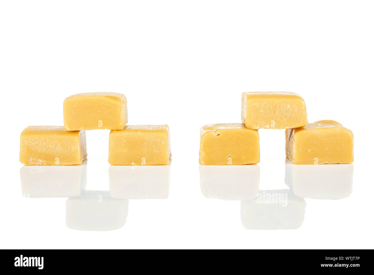 Group of six whole sweet golden caramel candy isolated on white ...
