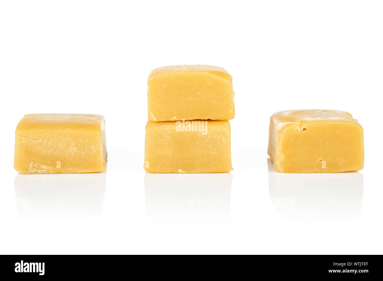 Group of four whole sweet golden caramel candy isolated on white ...