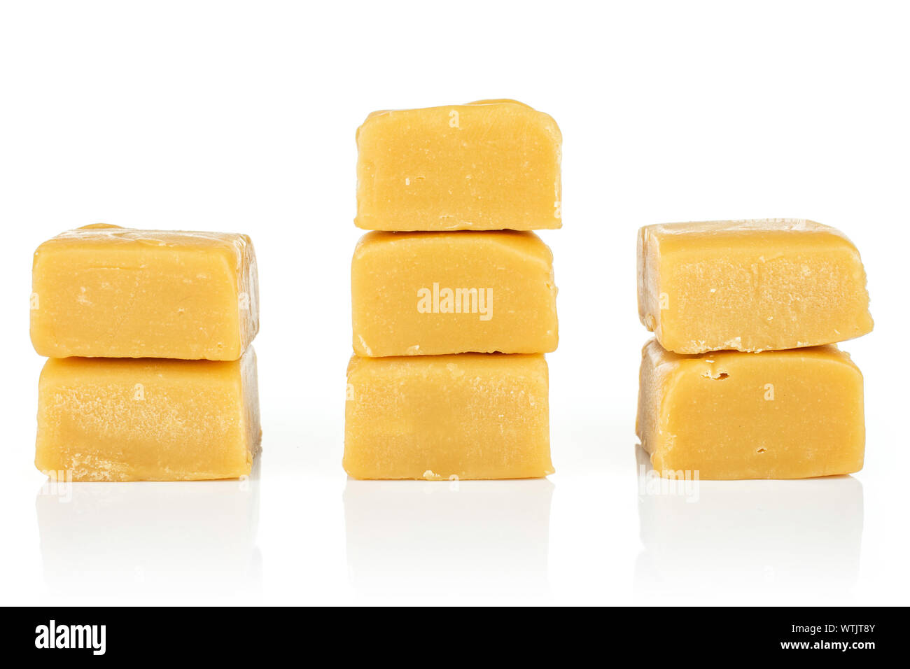 Group of seven whole sweet golden caramel candy isolated on white ...