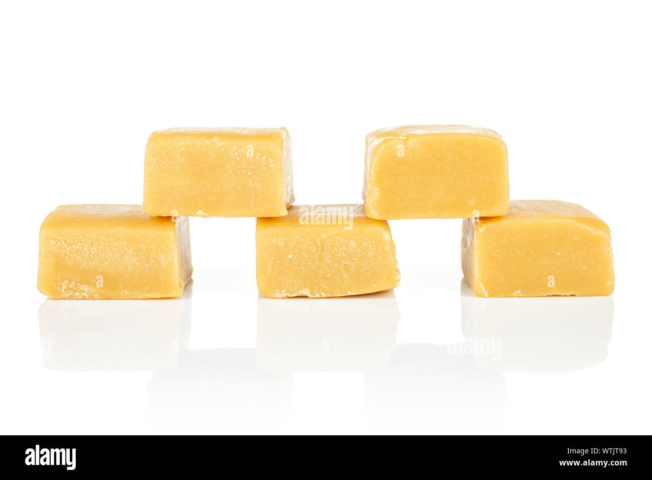 Group of five whole sweet golden caramel candy isolated on white ...