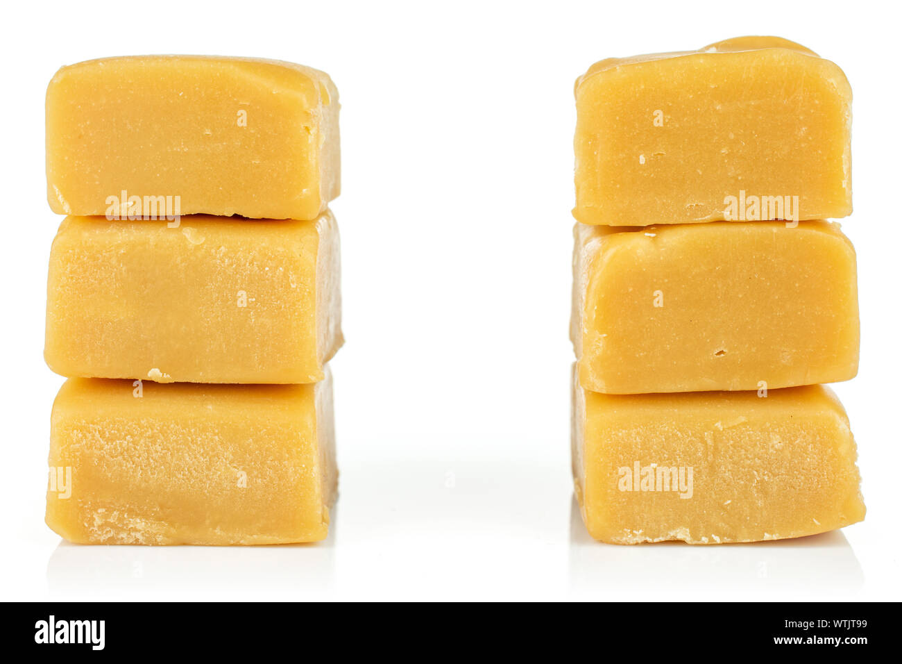 Group of six whole sweet golden caramel candy in two columns isolated ...
