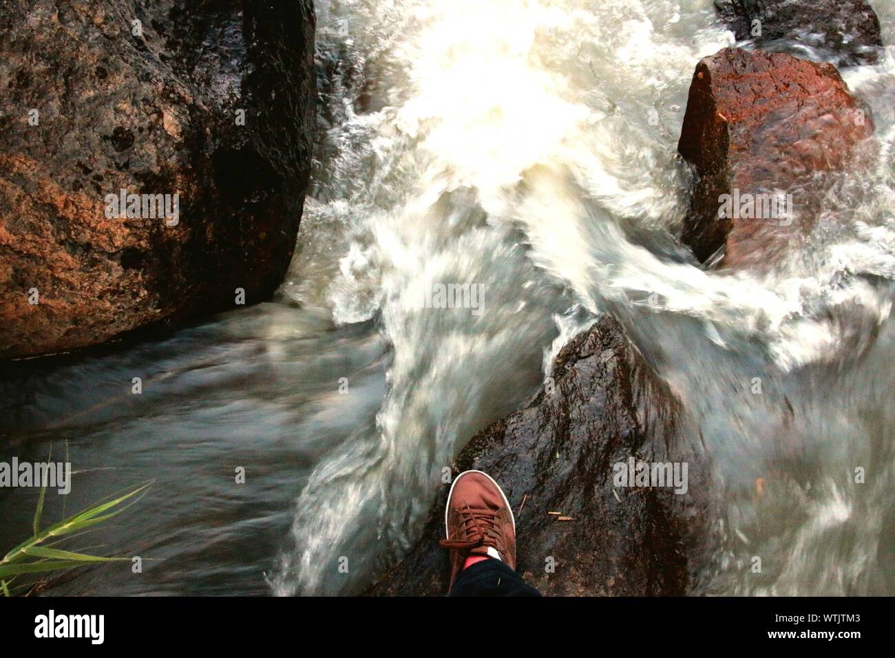 Person standing in front of waterfall hi-res stock photography and ...