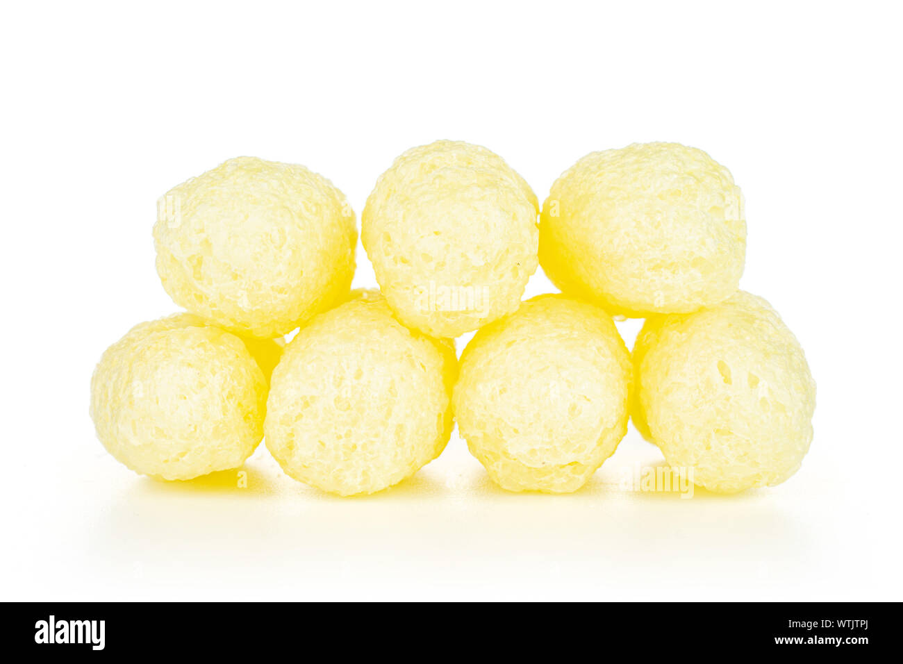 Group of seven whole salted yellow corn puff isolated on white ...