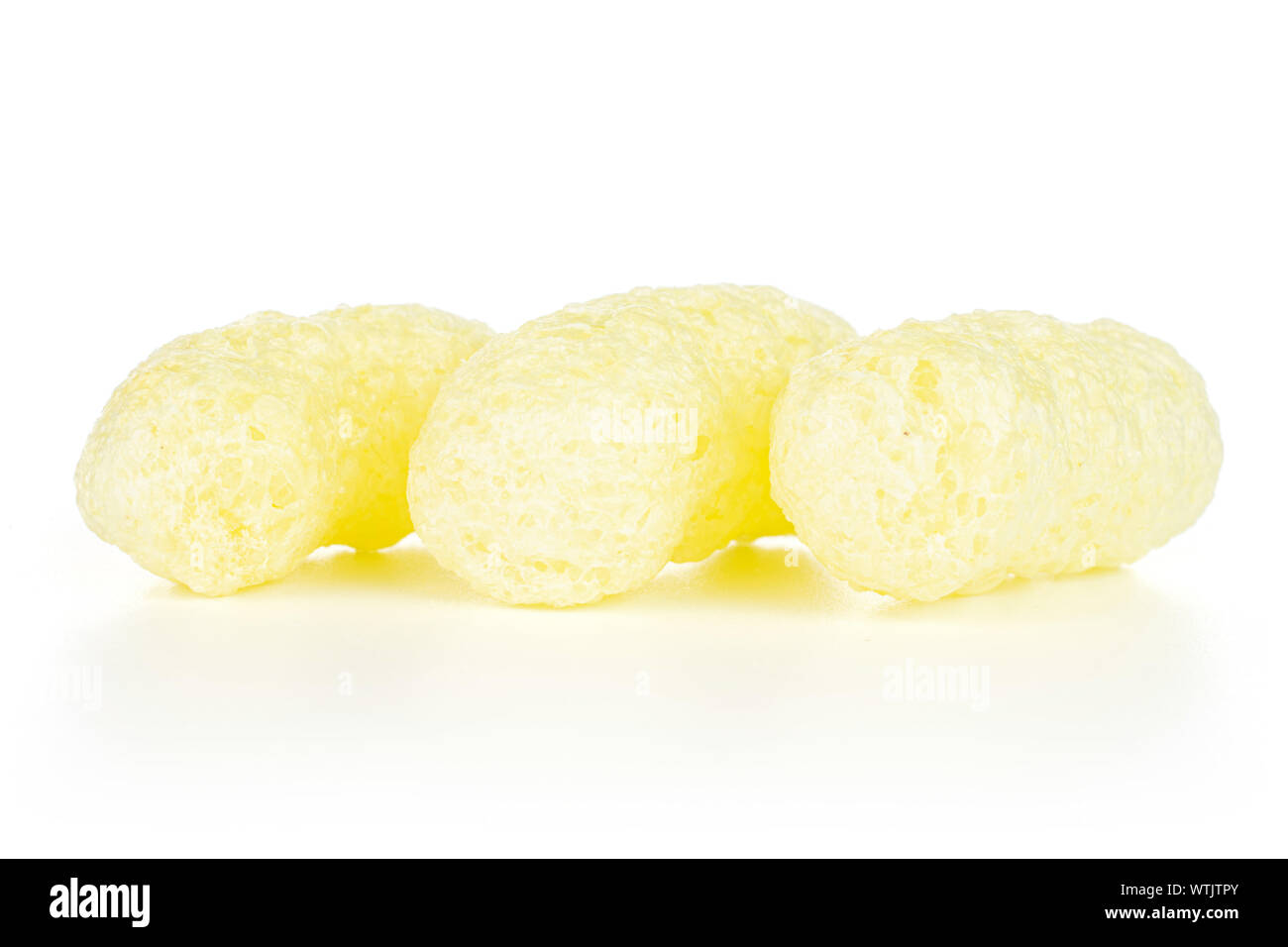 Group of three whole salted yellow corn puff isolated on white ...