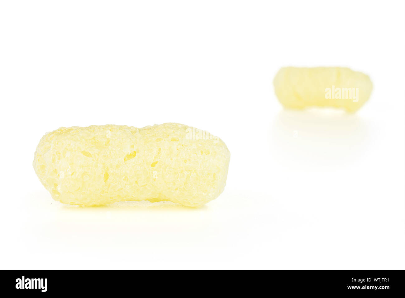 Group of two whole salted yellow corn puff isolated on white background ...