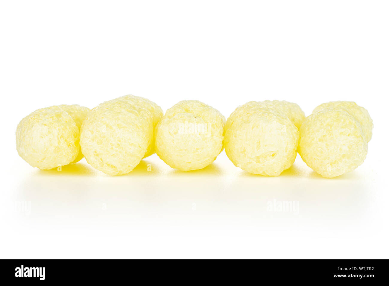 Group of five whole salted yellow corn puff isolated on white ...