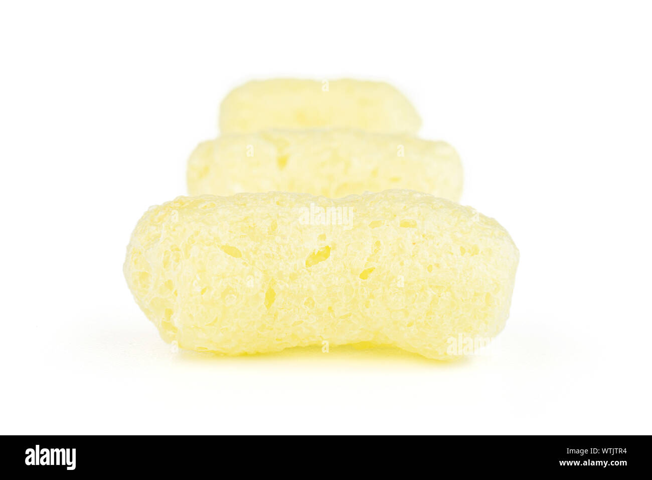 Group of three whole salted yellow corn puff isolated on white ...