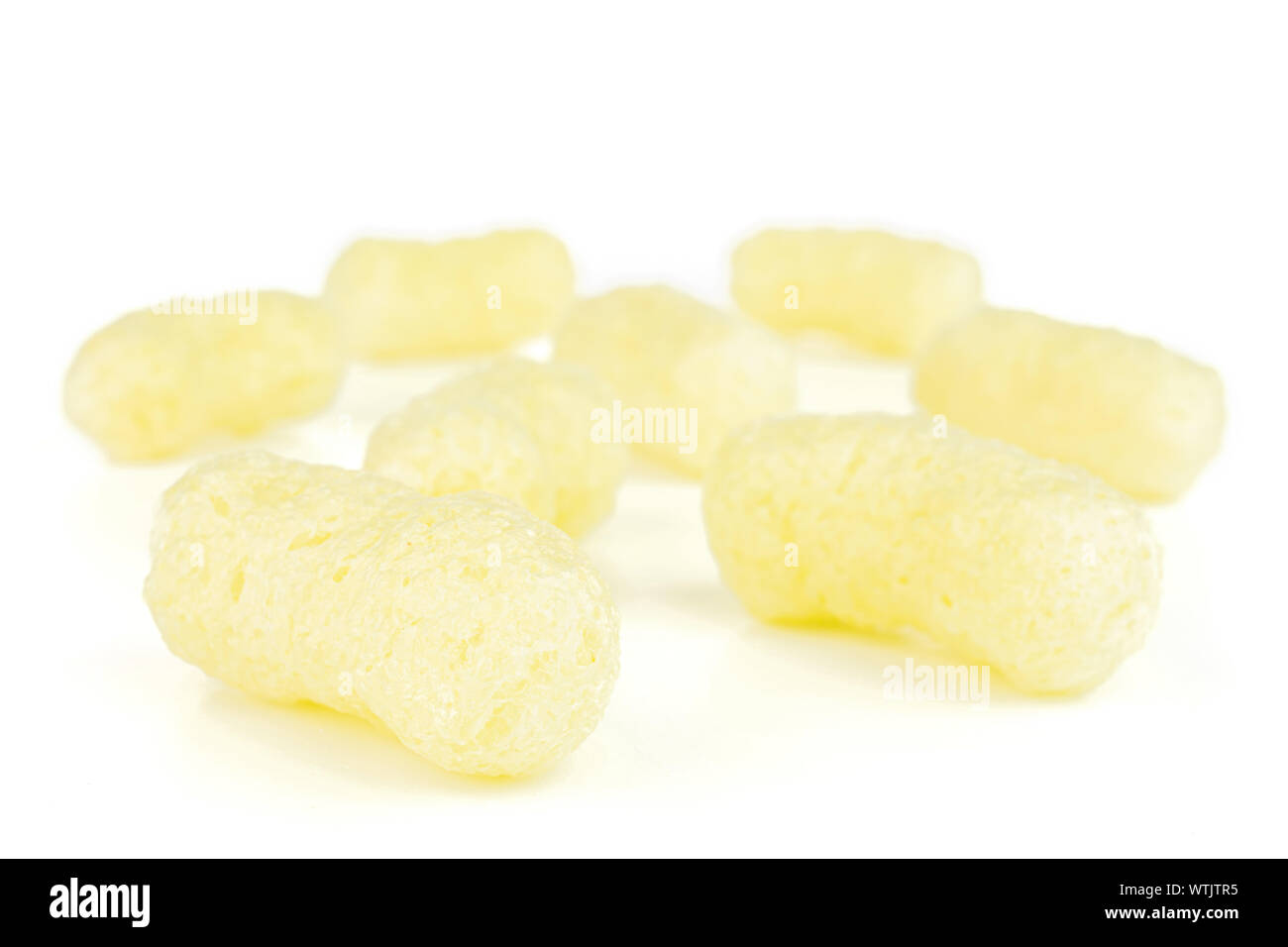 Group of eight whole salted yellow corn puff isolated on white ...