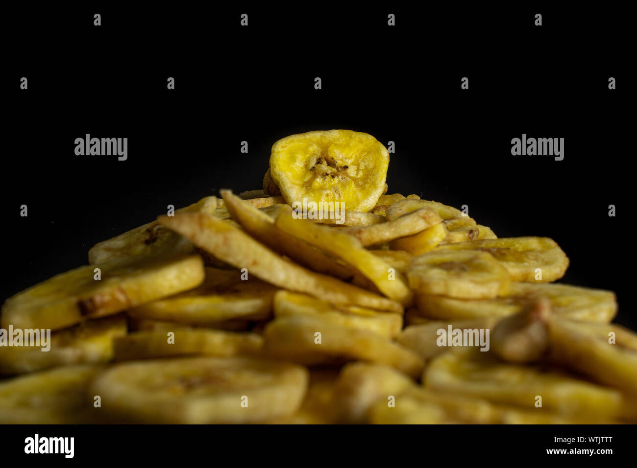 Lot of slices of sweet yellow dry banana isolated on black glass Stock ...