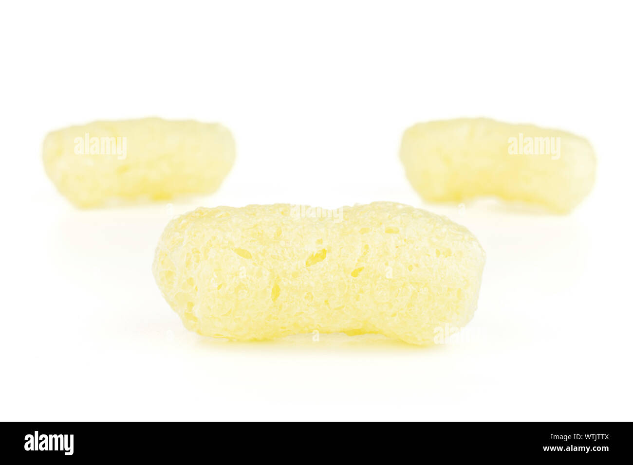 Group of three whole salted yellow corn puff isolated on white ...