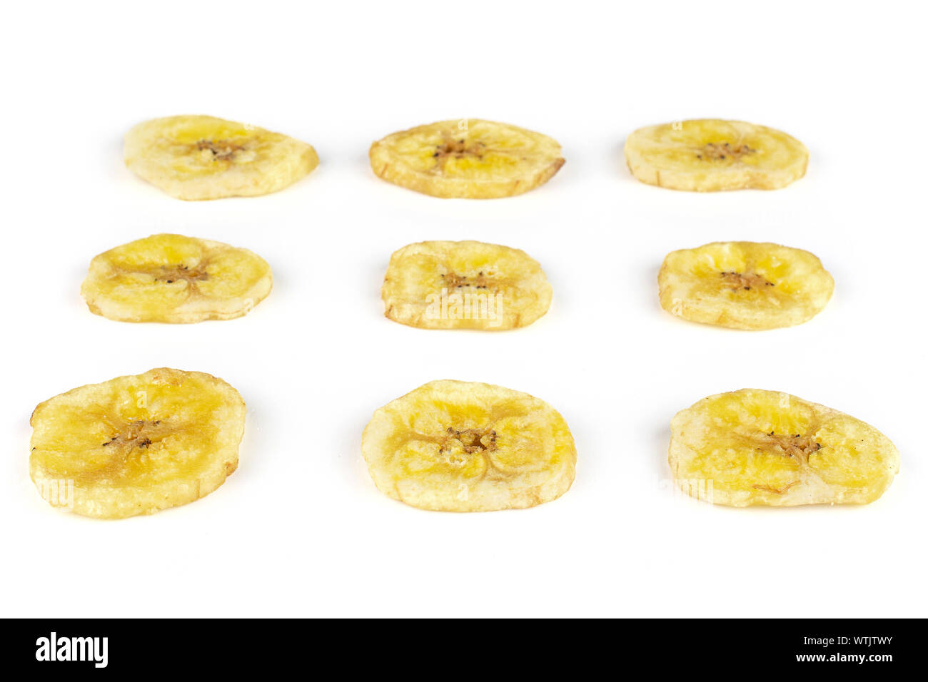 Group of nine slices of sweet yellow dry banana isolated on white ...