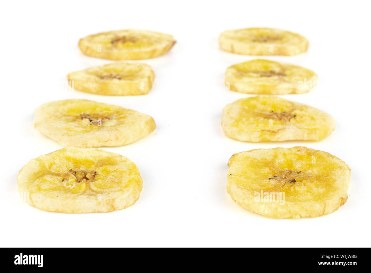 Group of eight slices of sweet yellow dry banana isolated on white ...